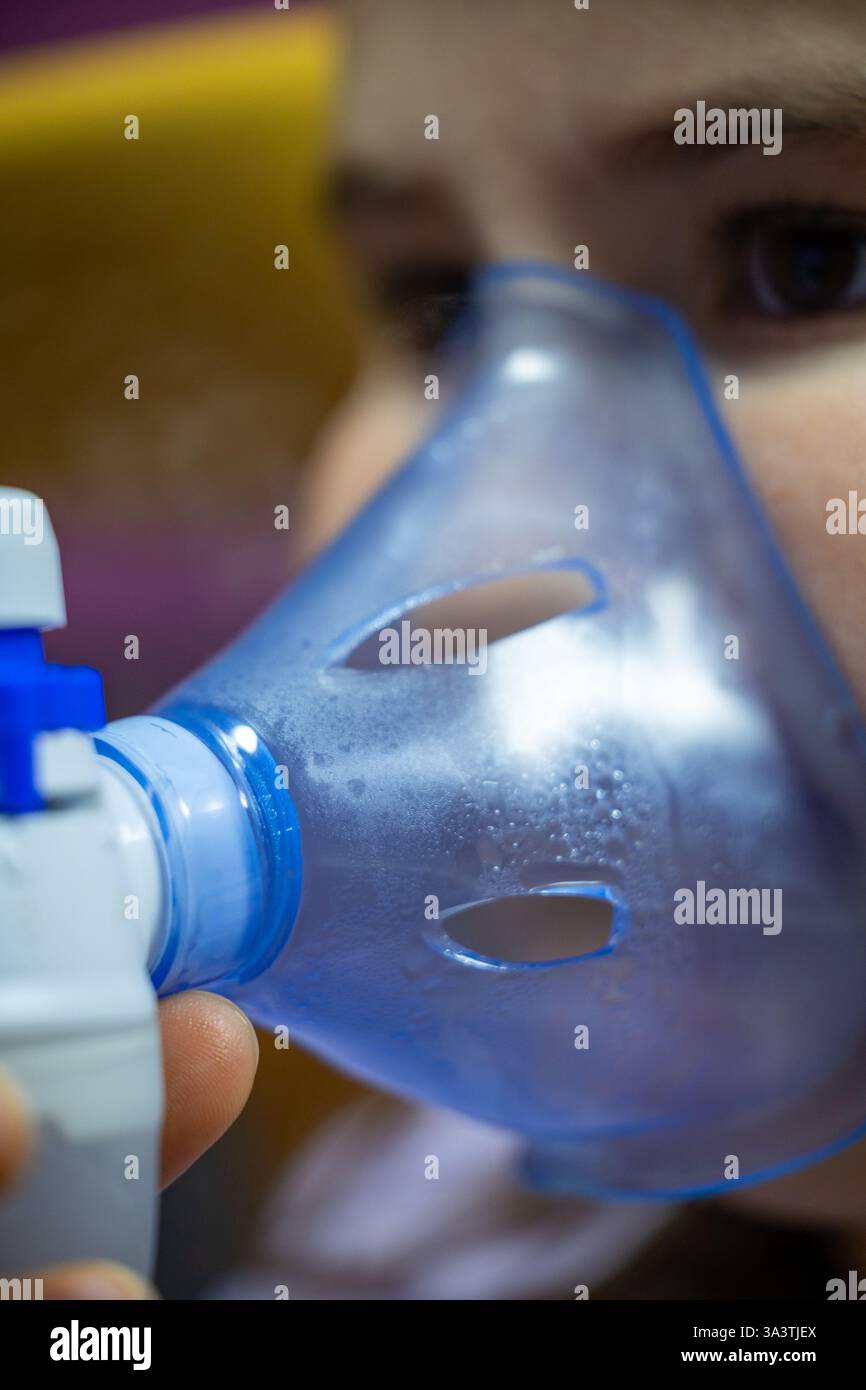 Child using a nebulizer for respiratory treatment in a comforting ...