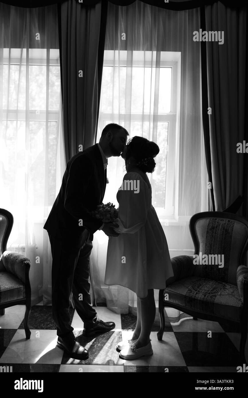 Silhouette shooting of a couple kissing against the background of a ...