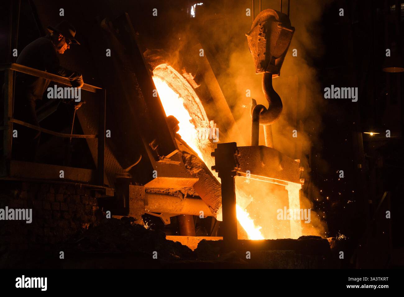 Metallurgist pouring hot molten hi-res stock photography and images - Alamy
