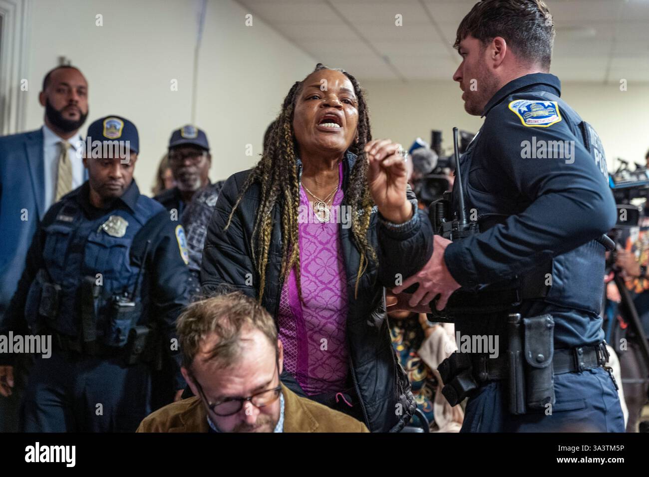 Karen Hylton, center, the mother of Karon Hylton-Brown, is removed as ...