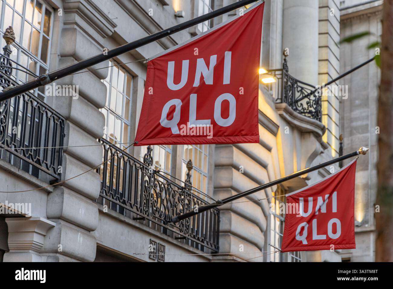 London, UK- September 19, 2024: UNIQLO Japanese shop logo red flag ...