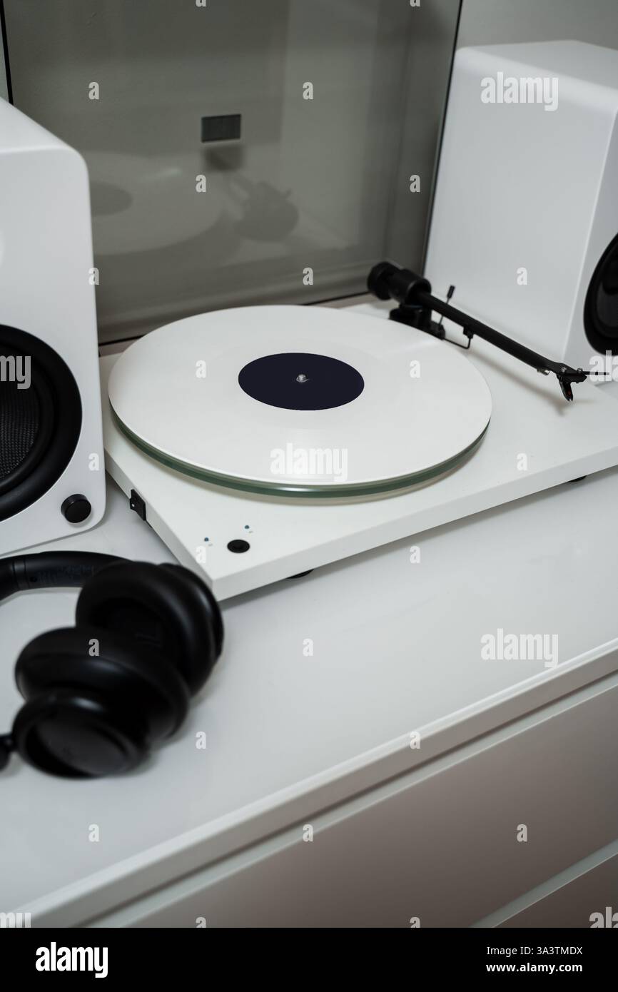 White vinyl player with speaker system and rock record in white shade ...