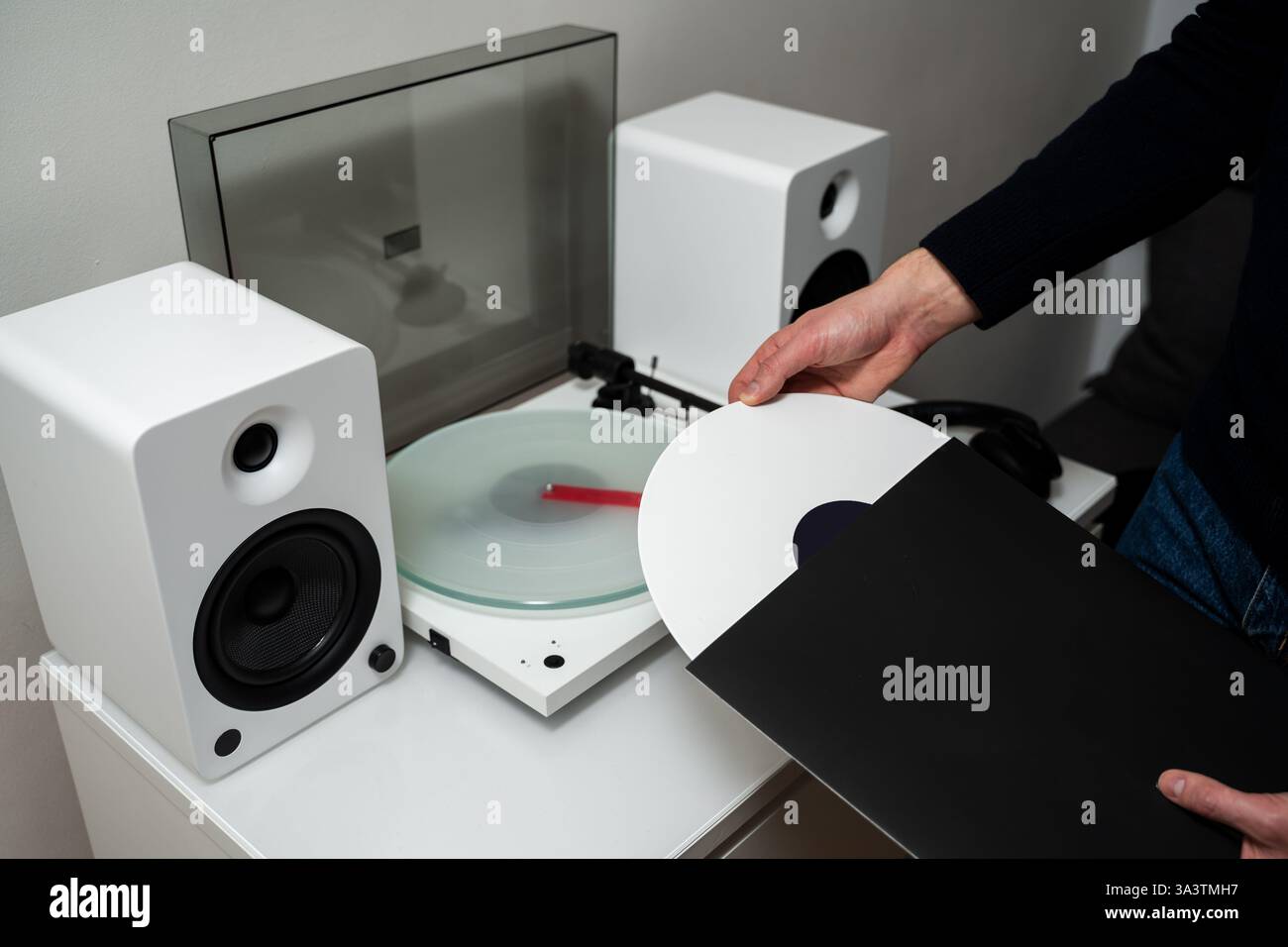 Musician changes vinyl record into turntable player and speaker system ...