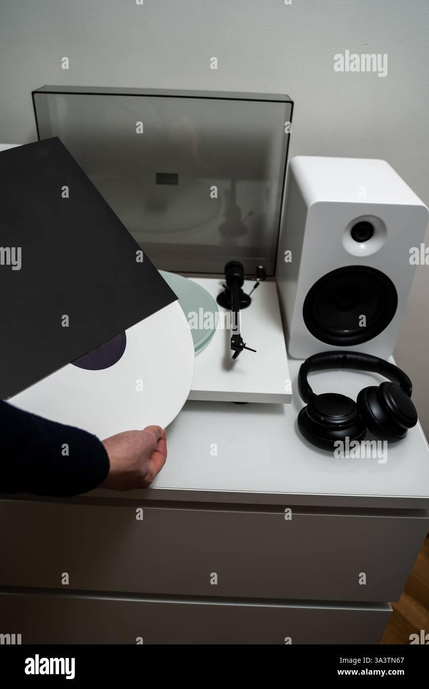 Musician changes vinyl record into turntable player and speaker system ...
