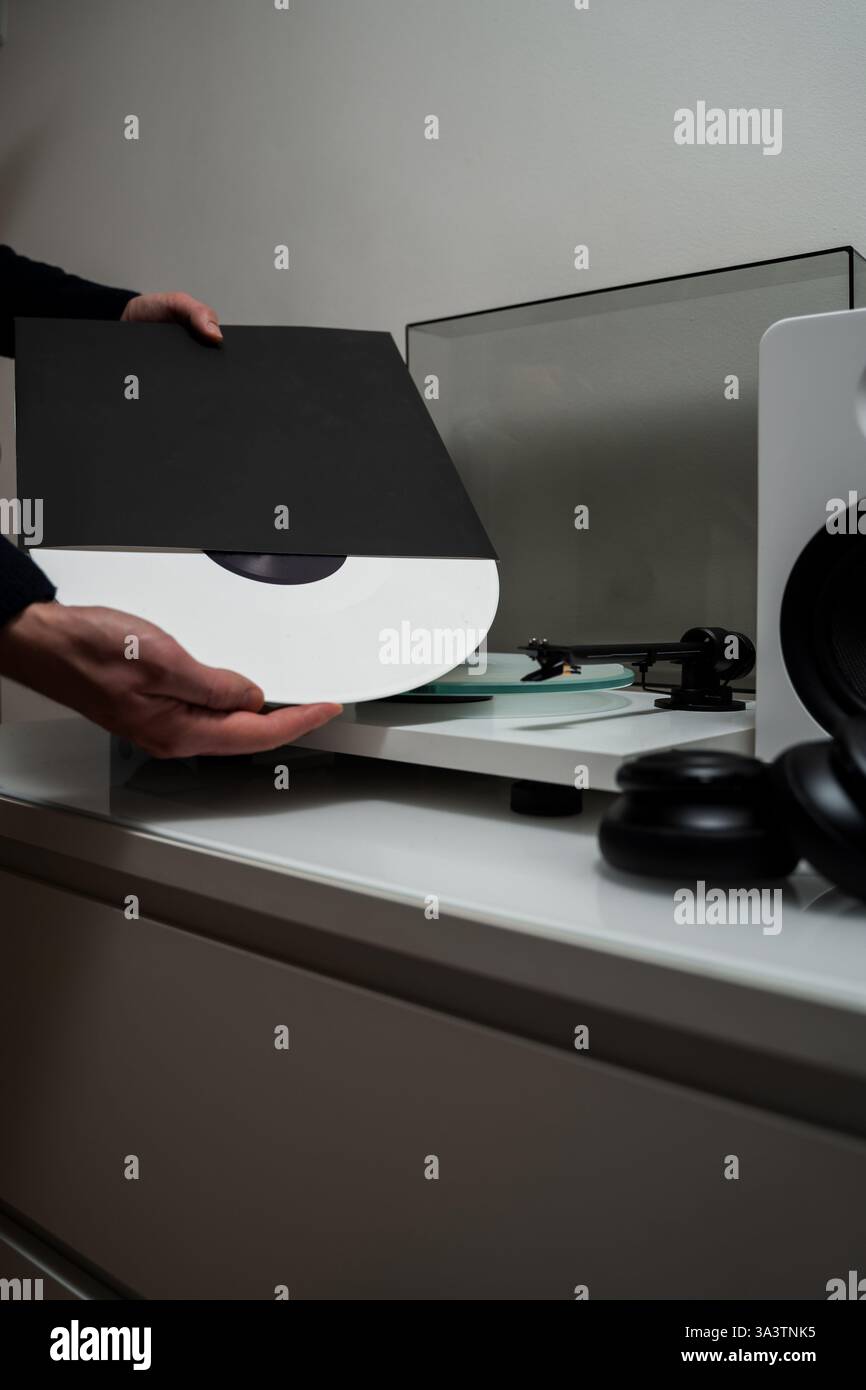Musician changes vinyl record into turntable player and speaker system ...