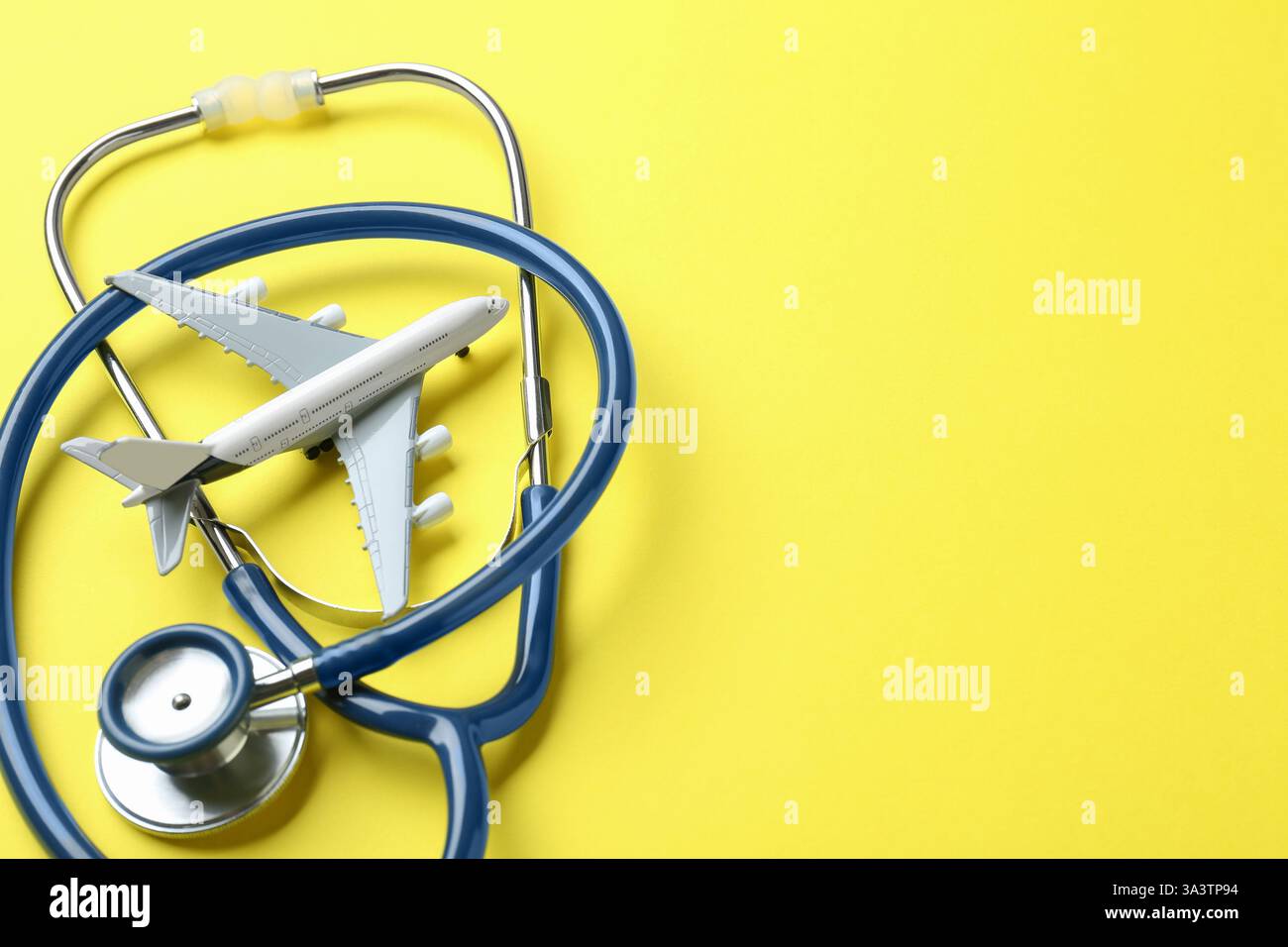 Medical tourism. Stethoscope and plane model on yellow background ...