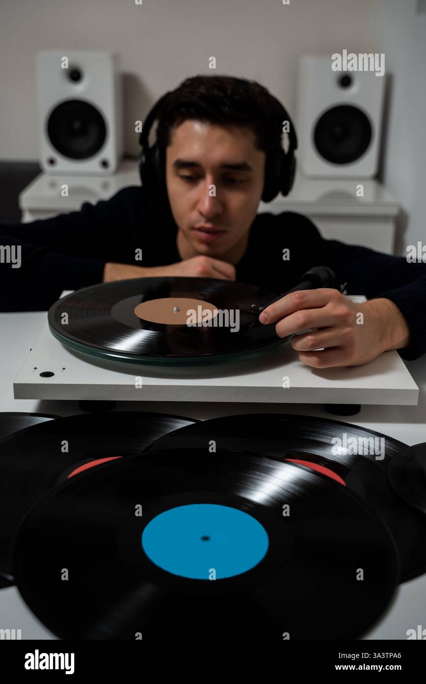 Musician listens a vinyl album collection on a needle player. Music ...