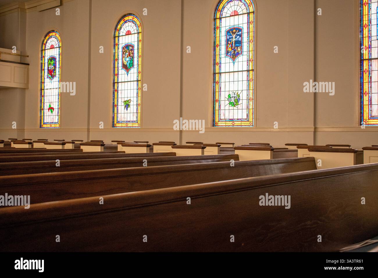 Interior church pews and stained glass windows Stock Photo - Alamy