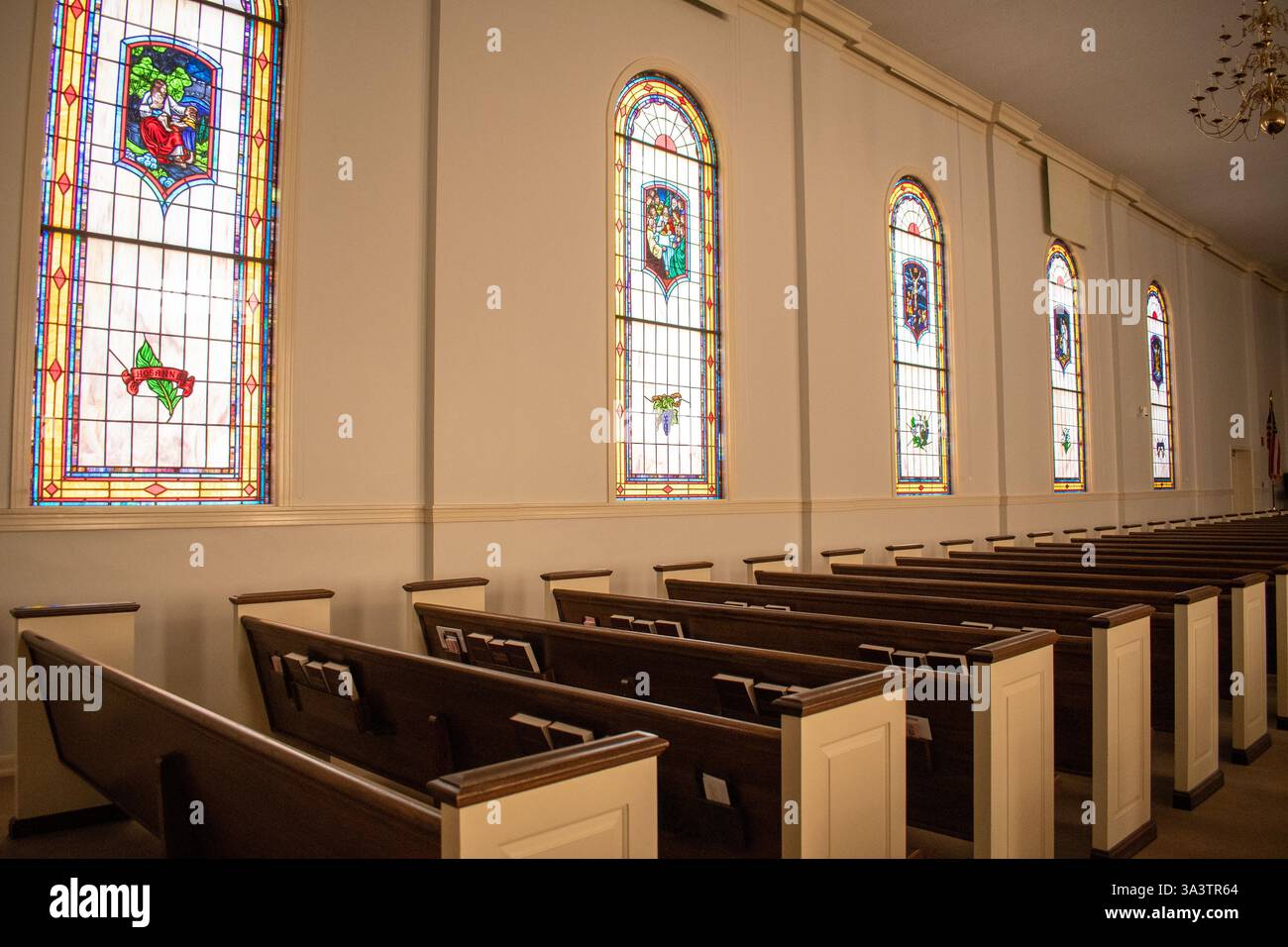 Interior church pews and stained glass windows Stock Photo - Alamy