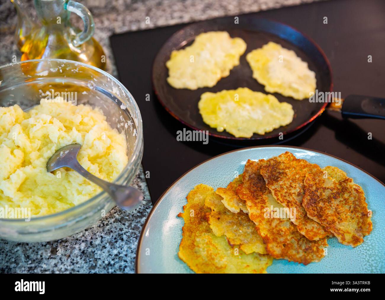 Cooking process of traditional Ukrainian deruny from grated potatoes ...