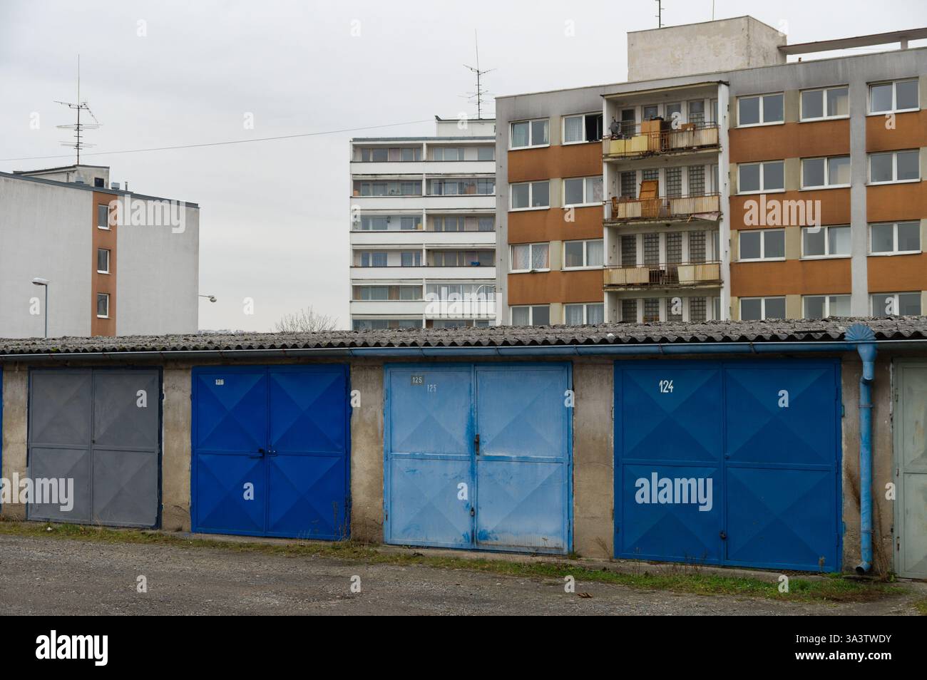 Weathered garages by communist style prefabricated concrete apartment ...