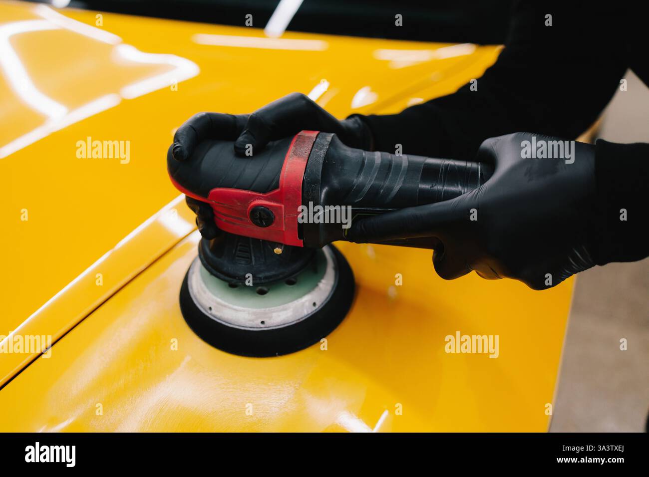 Detailing process of polishing yellow sports car hood surface using ...