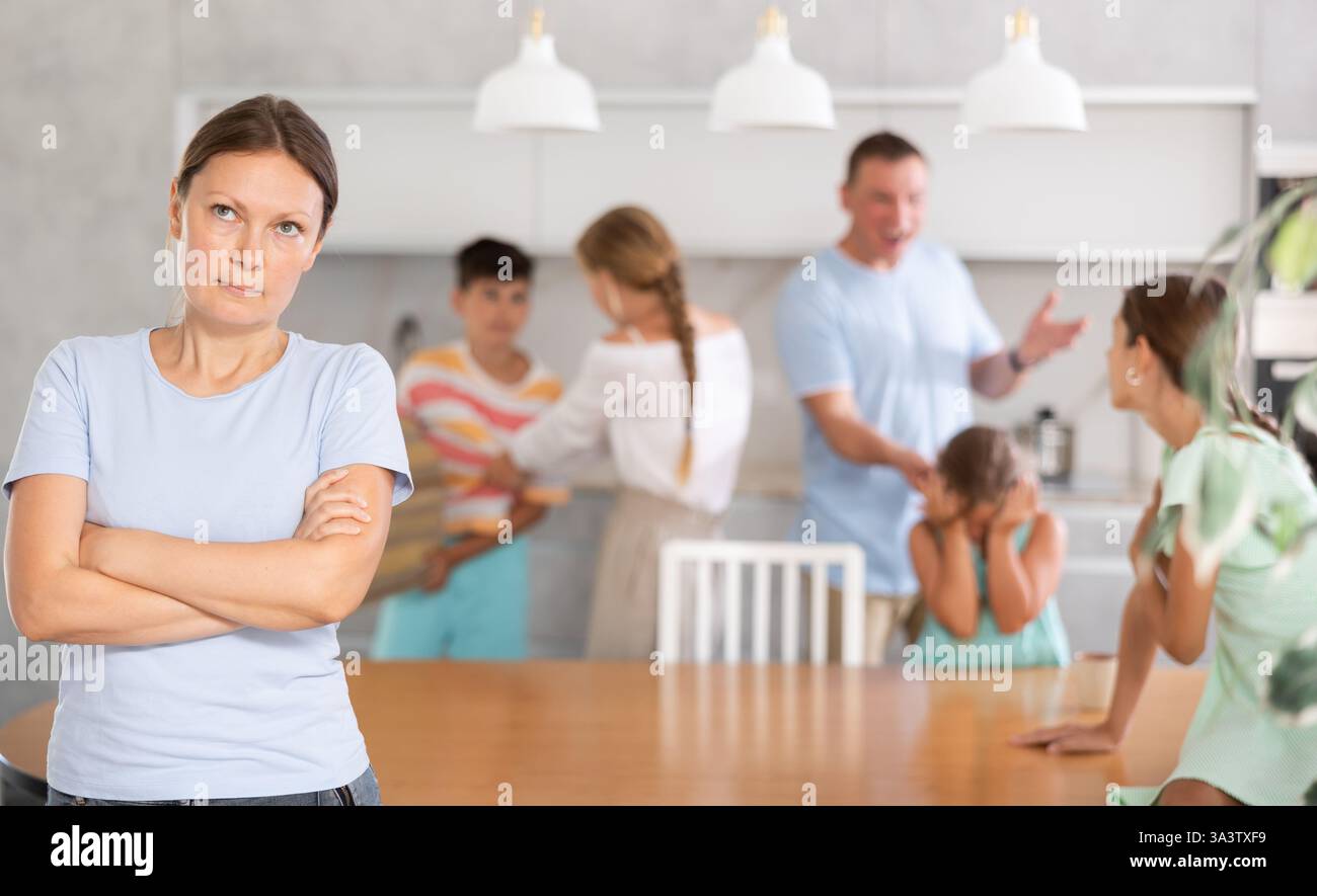 Irritated mom is tired of noise and screams of the children at home ...