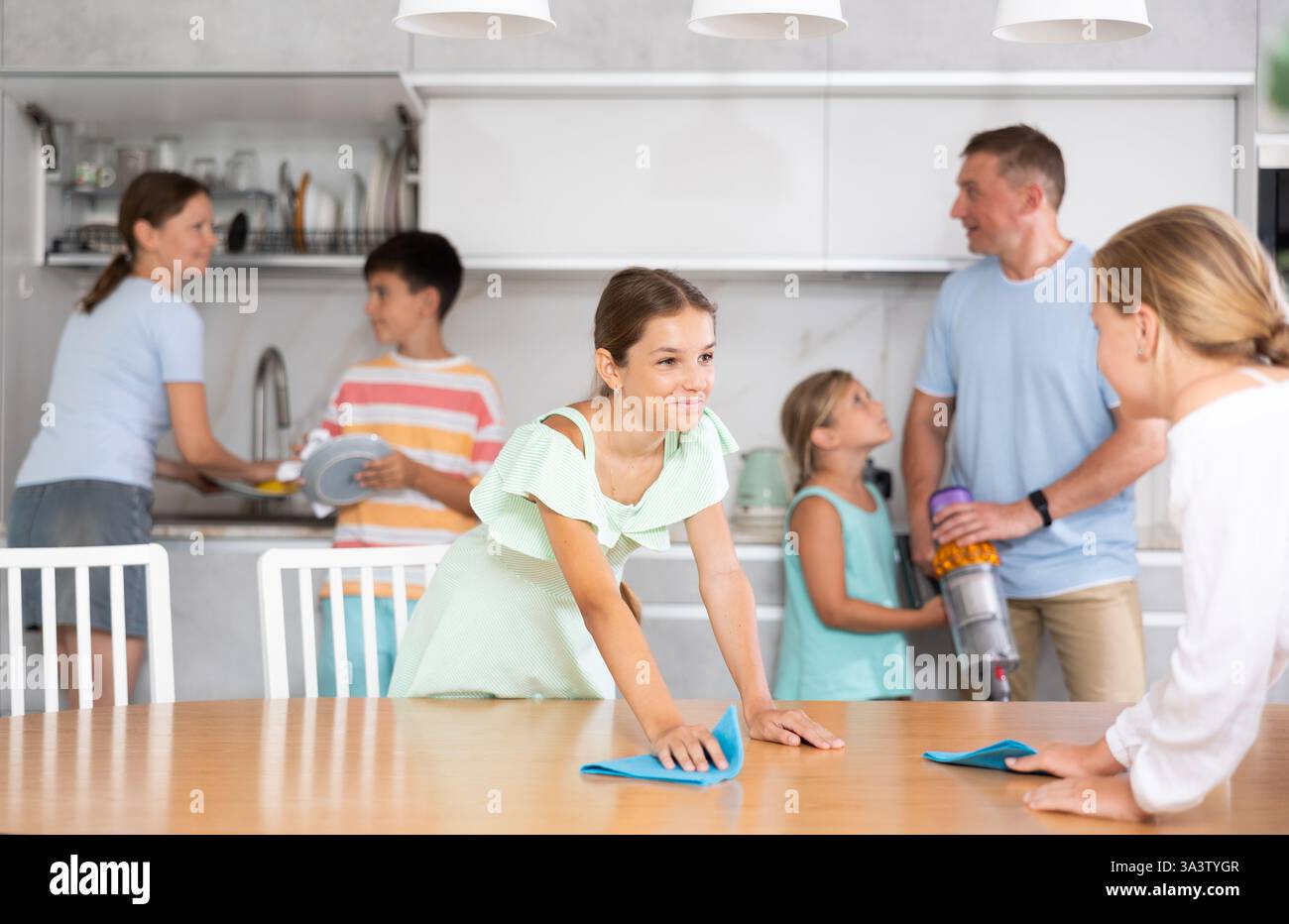 Children in large family help their parents to clean room Stock Photo ...
