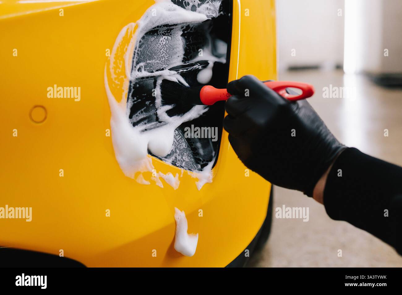 Car detailing procedure at the car wash. Cleaner washes air system with ...