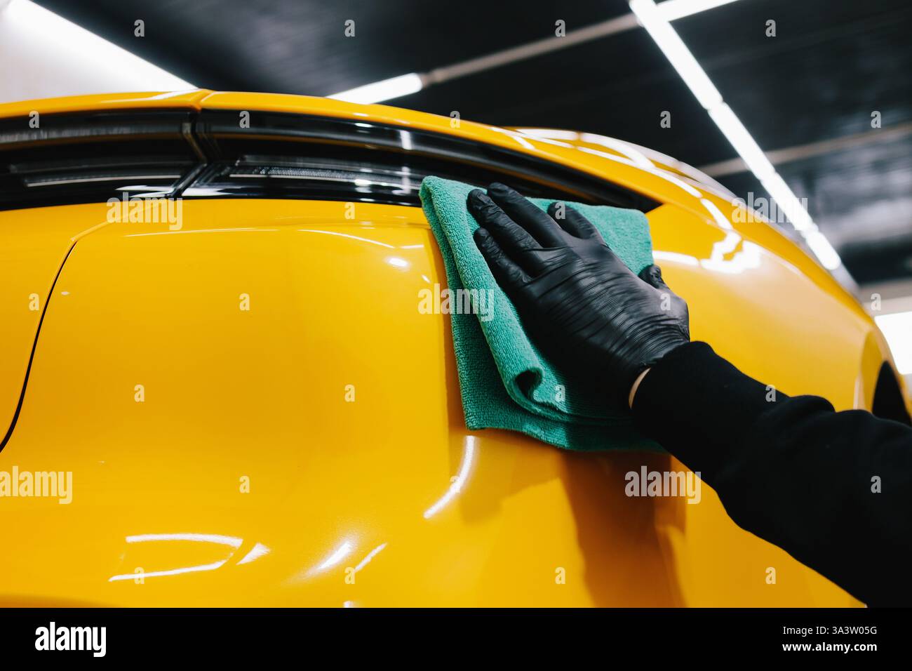 Manual washing and polishing car with microfiber cloth after detailing ...