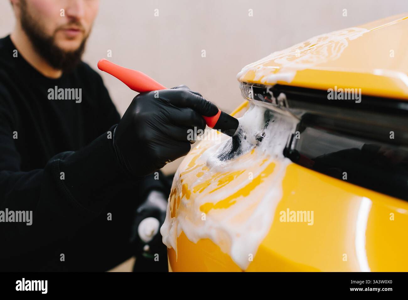 Detailing cleaning with brush and foam at the car wash. Procedure of ...