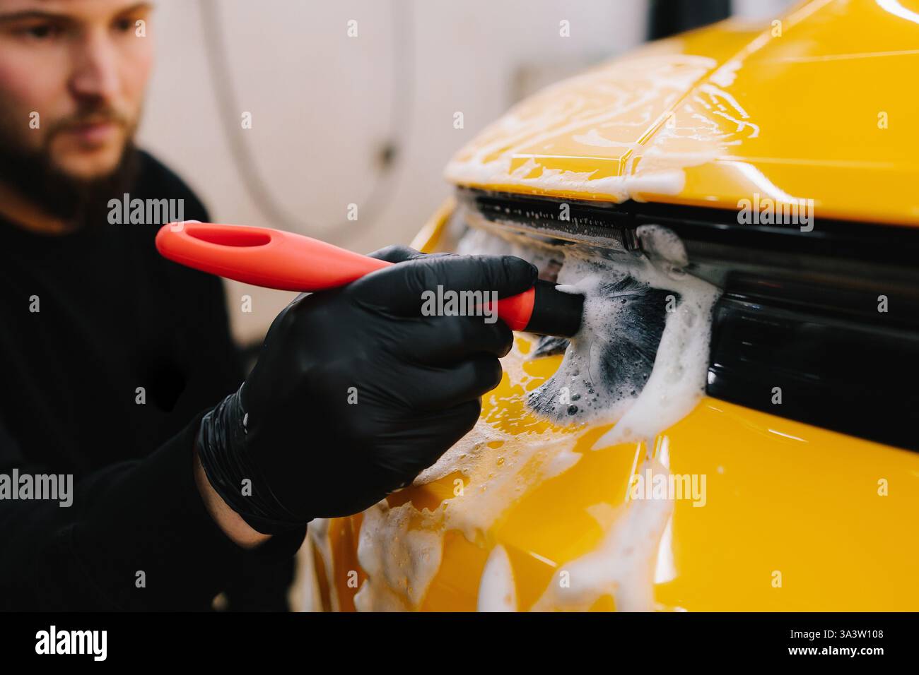 Detailing cleaning with brush and foam at the car wash. Procedure of ...