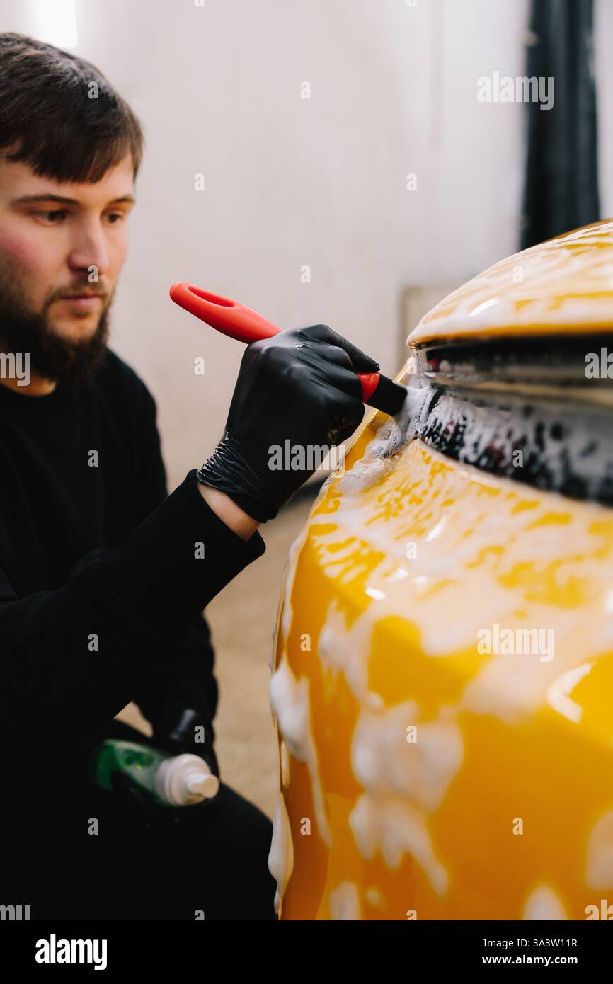 Detailing cleaning with brush and foam at the car wash. Procedure of ...
