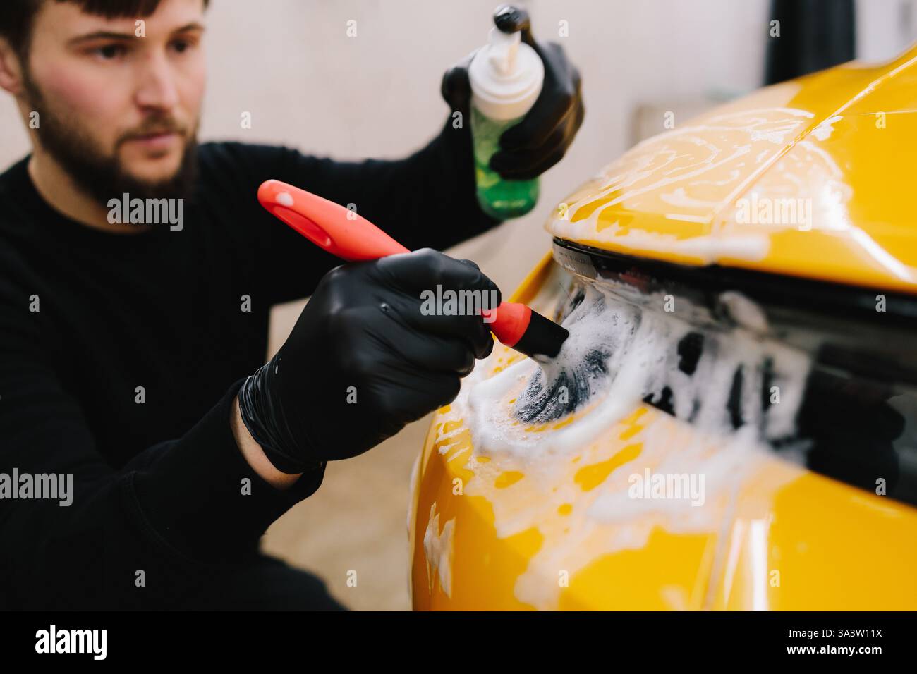 Detailing cleaning with brush and foam at the car wash. Procedure of ...