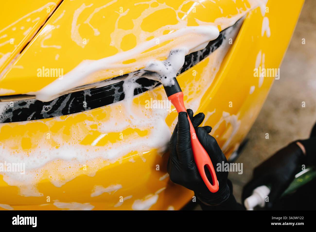 Detailing cleaning with brush and foam at the car wash. Procedure of ...