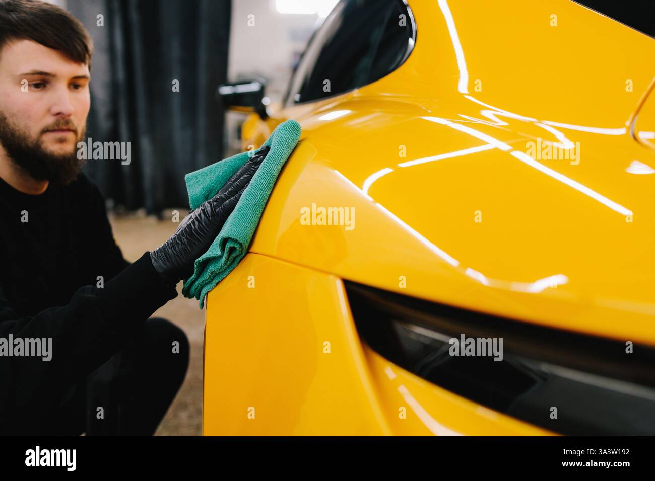 Microfiber hand cleaning and washing sports car using microfiber towel ...