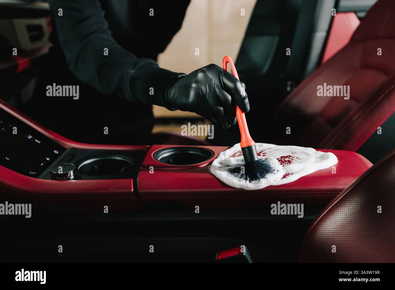 Car detailing process of cleaning leather auto interior with soap foam ...