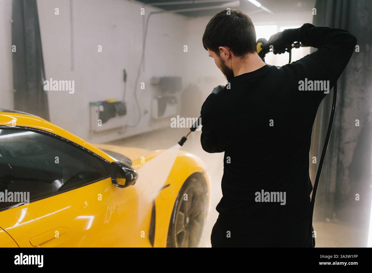 Detailing process of washing car from water gun at the car wash ...