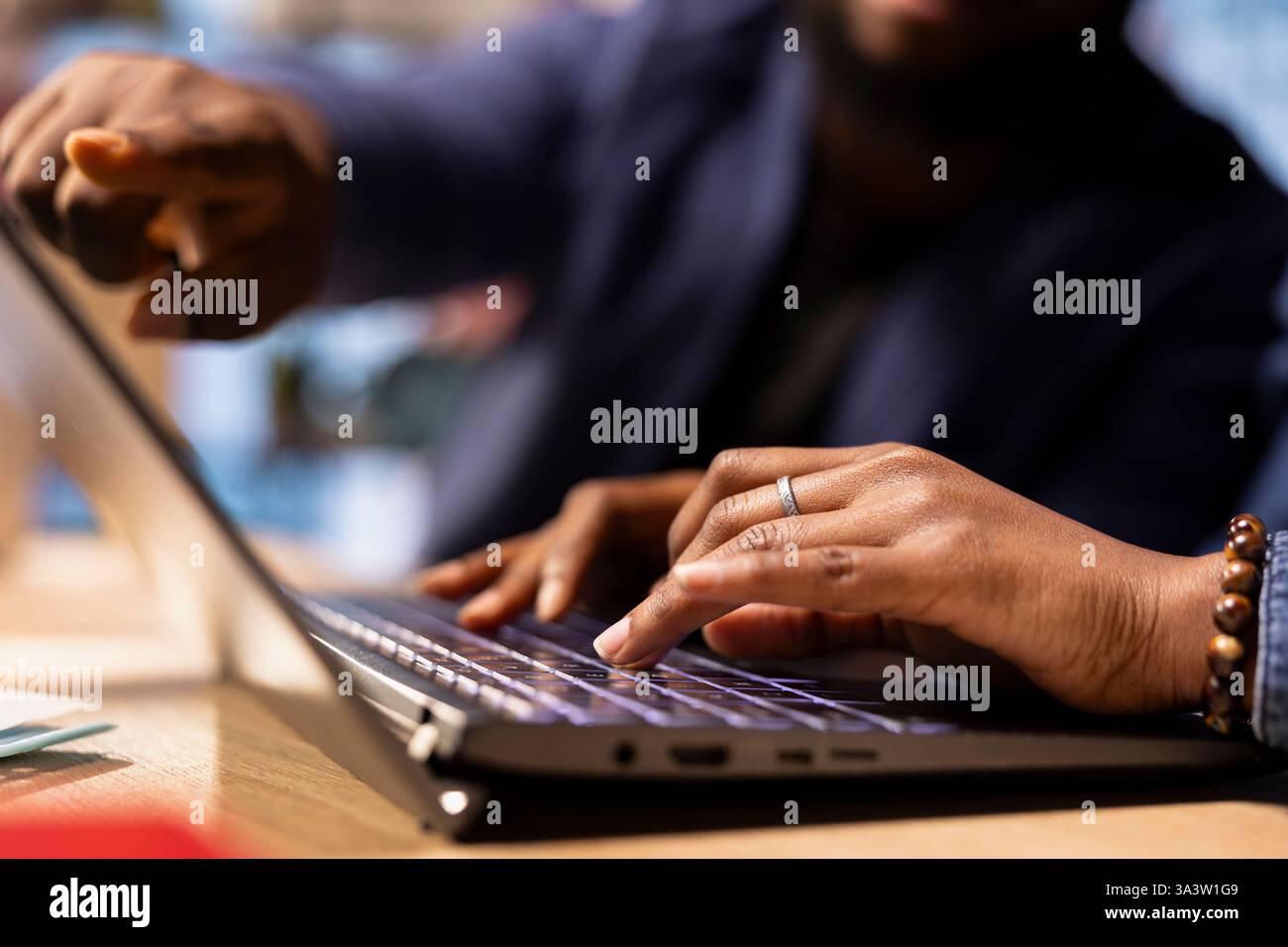 Black man and woman sits together in their cozy apartment space, discussing digital marketing ...