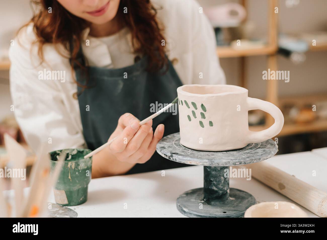 Process of designing cup with a traditional pattern in pottery art ...