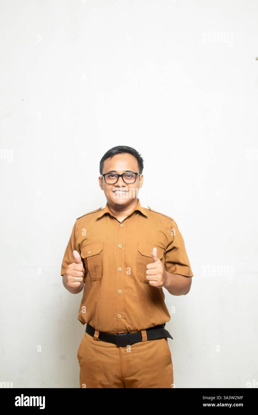 Man in khaki civil servant uniform in indonesia gives thumbs up ...