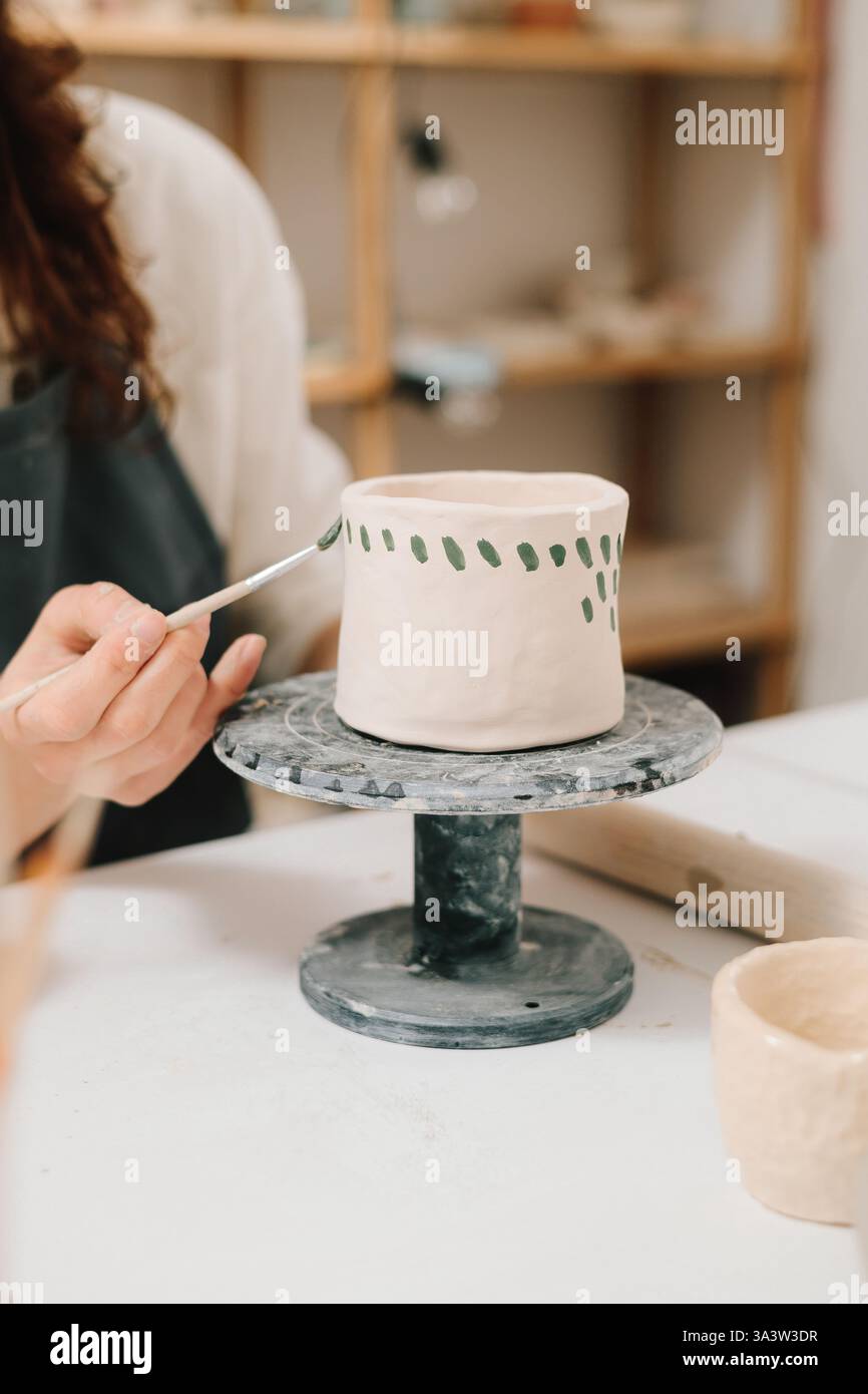 Process of designing cup with a traditional pattern in pottery art ...