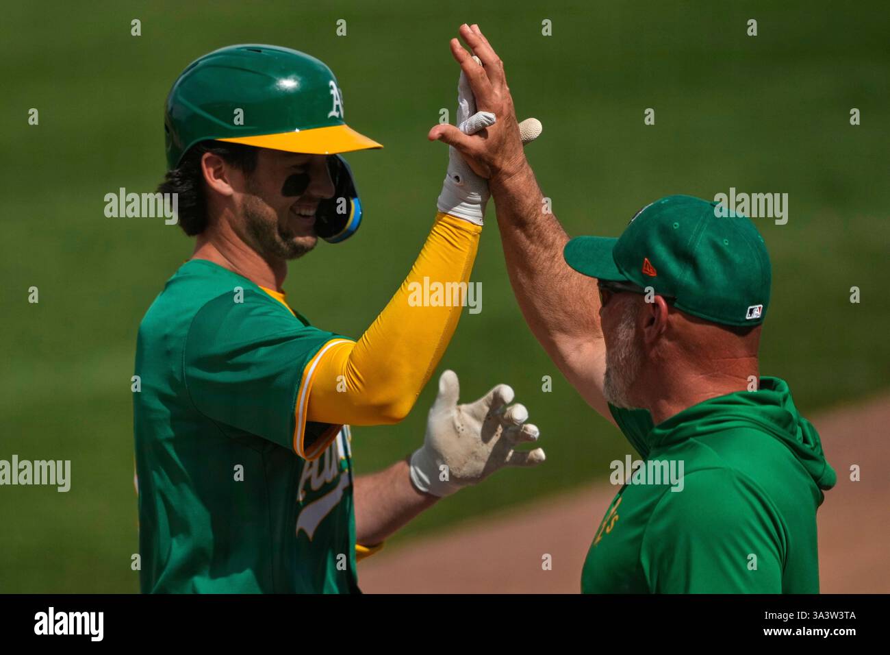 Athletics' Jacob Wilson, left, high fives manager Mark Kotsay after ...