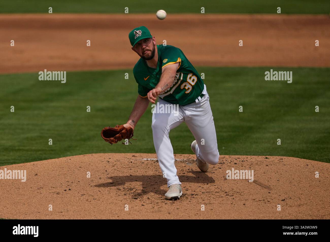 Athletics pitcher Hogan Harris throws against the Seattle Mariners ...
