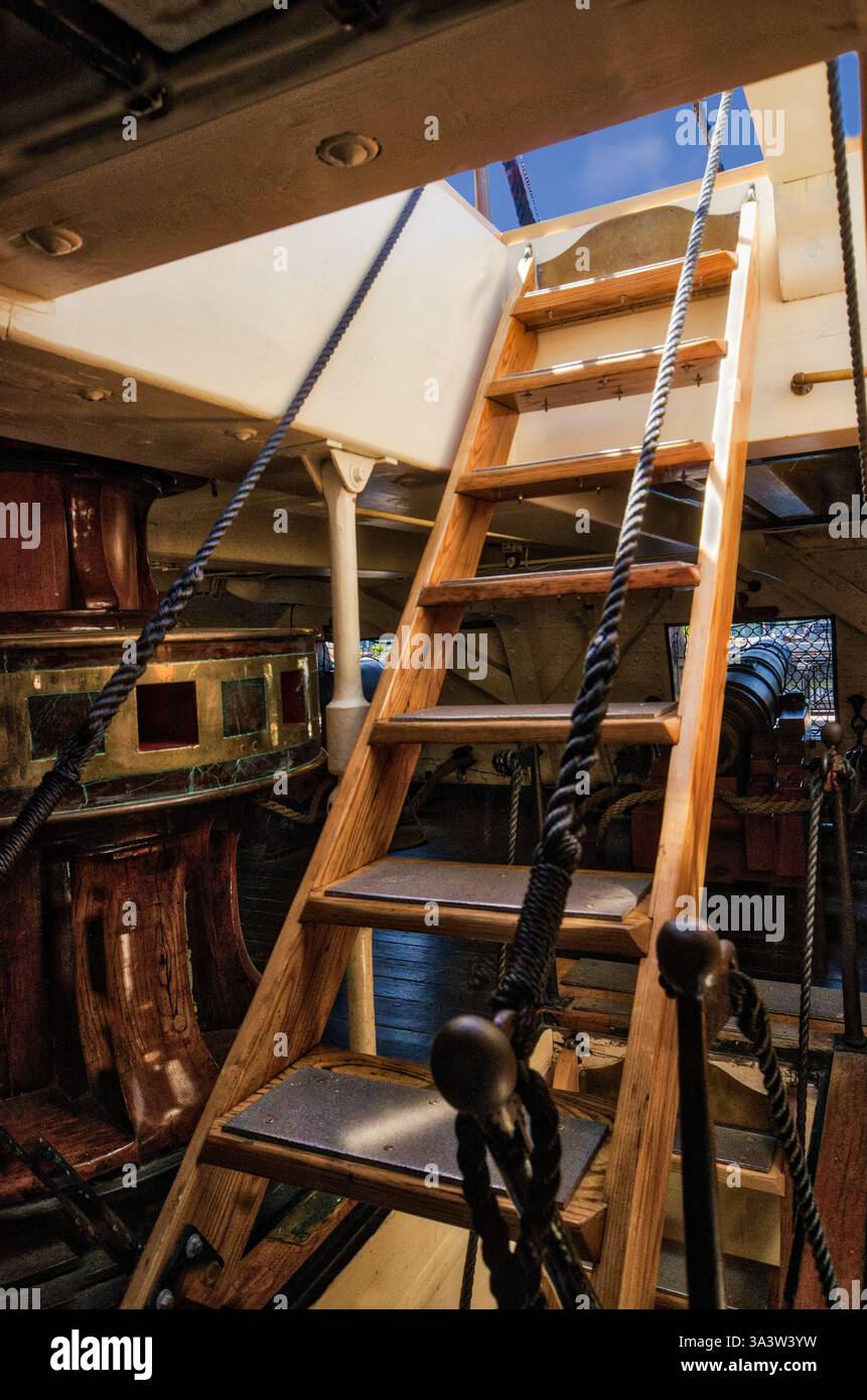 the crew ladder leading out from below deck to a sun bathed deck of the ...