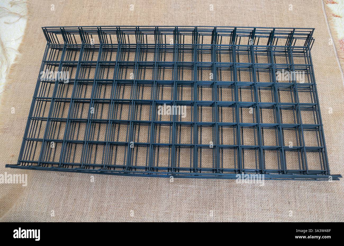 Black wire mesh grid, rectangular in shape, with a large surface area ...