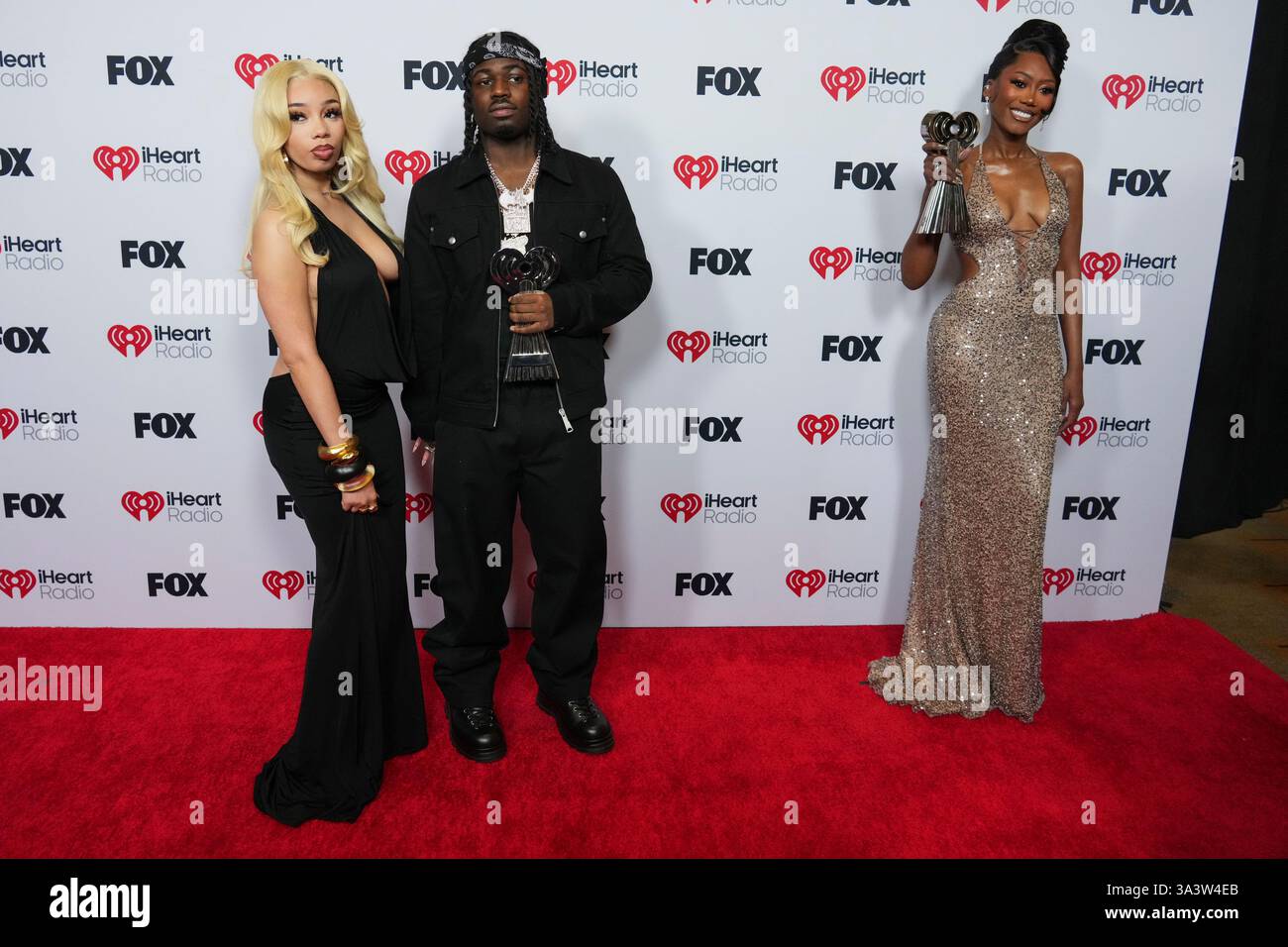 Anycia, from left, 4Batz, and Muni Long arrive at the iHeartRadio Music ...
