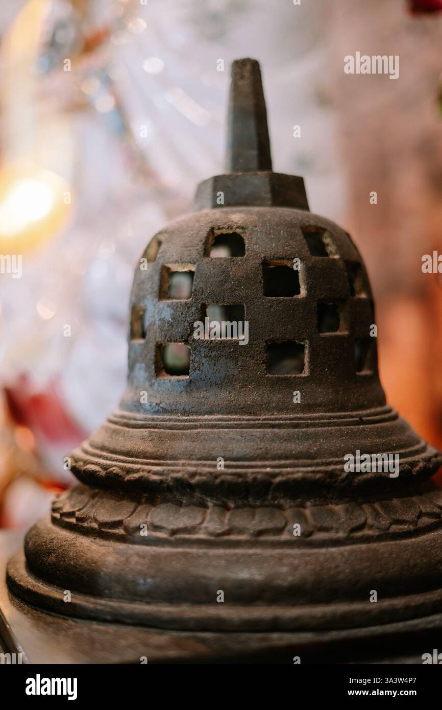Close-up image of a stone miniature stupa replica with square openings ...