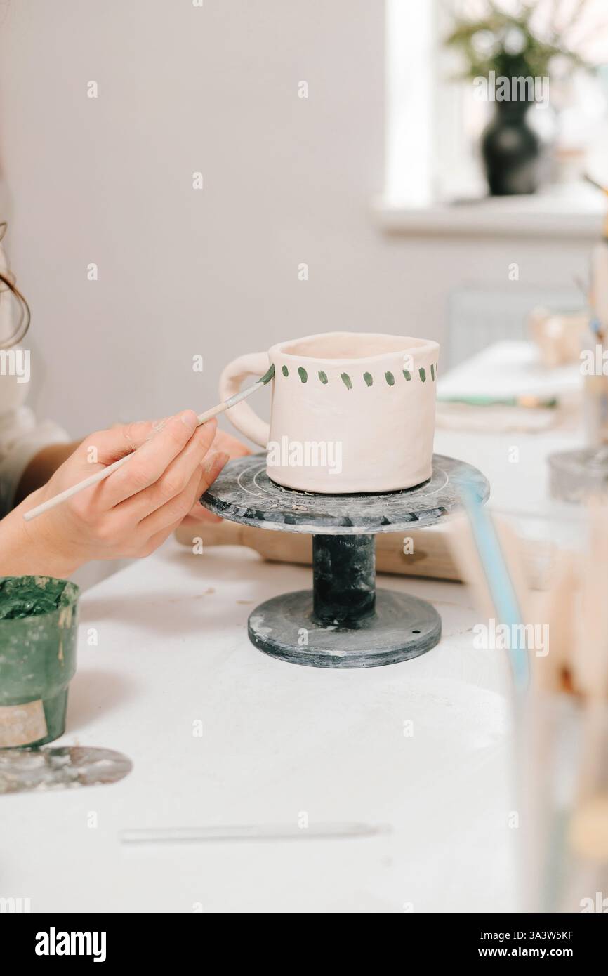 Process of designing cup with a traditional pattern in pottery art ...