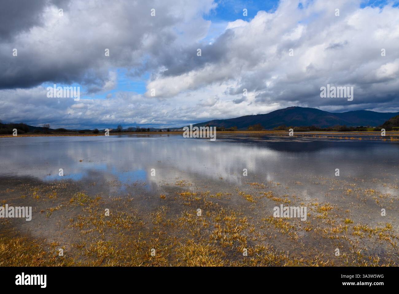 Beautiful view of lake Cerknica and Slivnica hill with clouds in the ...