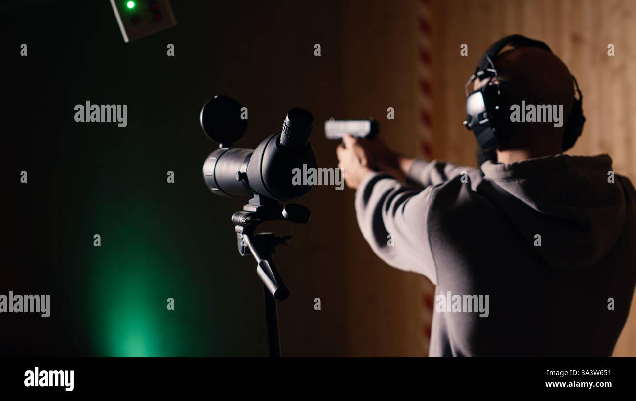 Friends in firing range doing recreational shooting, using magnifying ...