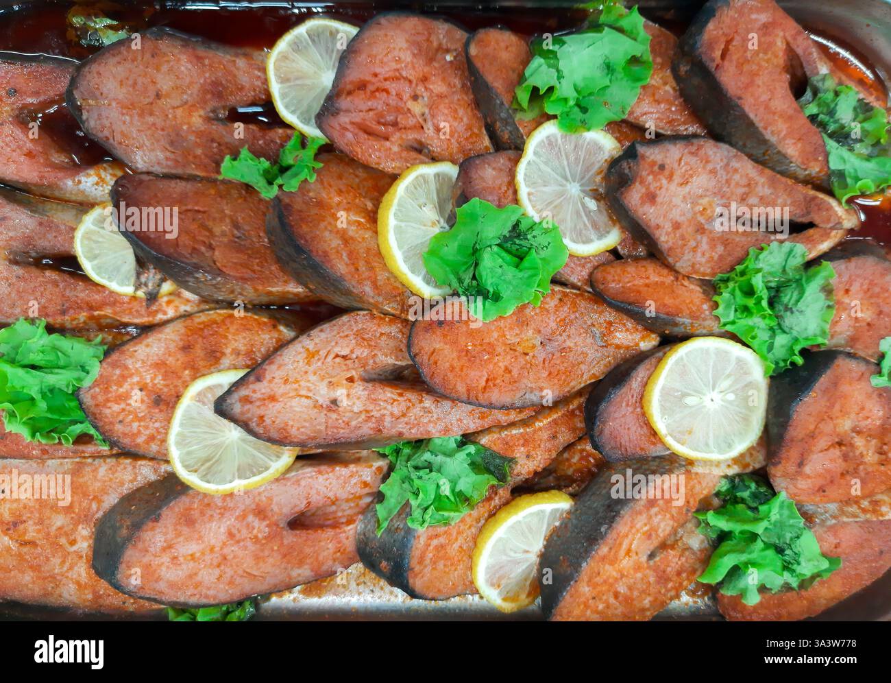 Red fish steaks marinated with lemon and spices for grilling Stock ...