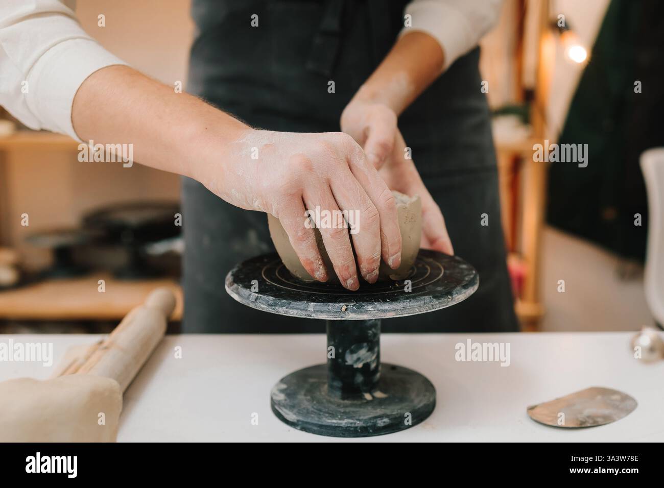 Artisan sculpts ceramic bowl using potter's wheel. Hands shaping clay ...