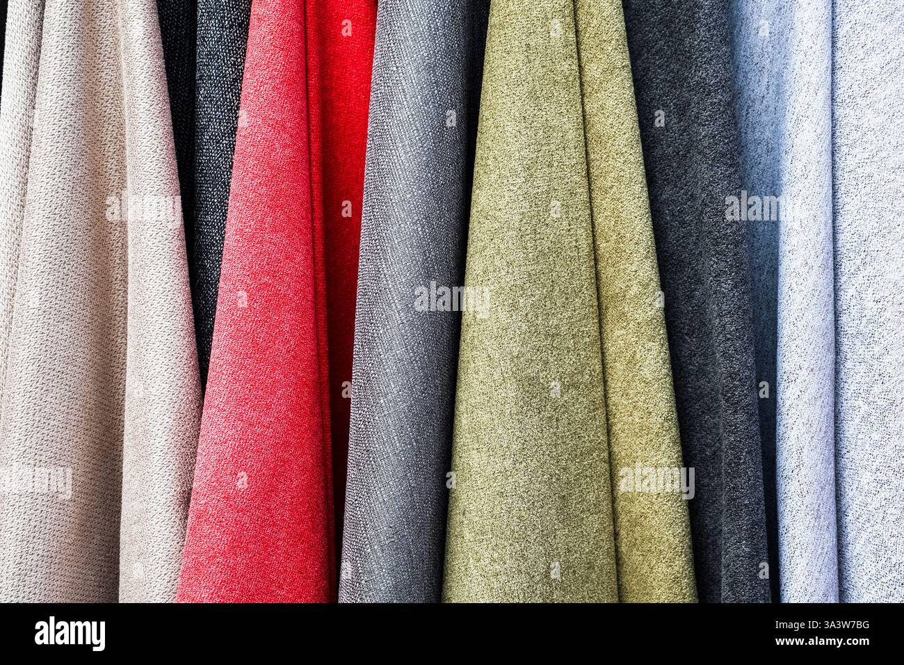 Variety of colorful fabrics hanging in a store, showcasing diverse ...