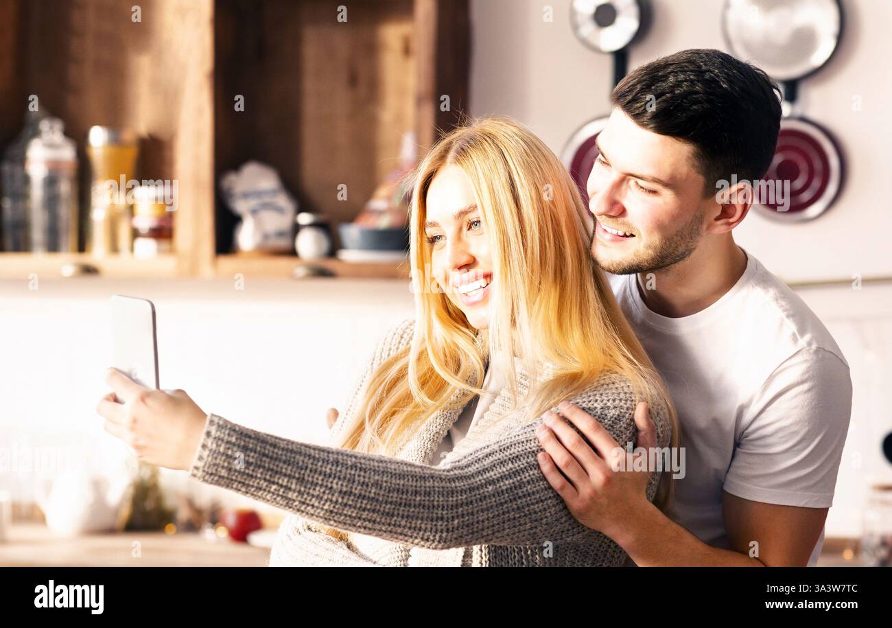 Couple enjoys a cozy moment taking a selfie together in a modern ...