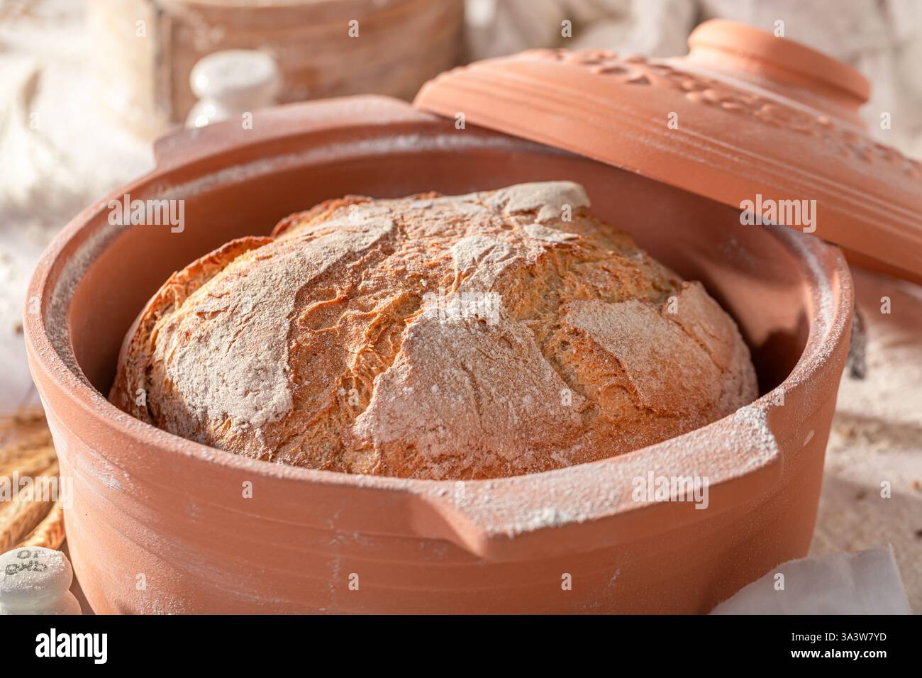 Healthy and hot loaf of bread in ceramic baking tin. Rustic loaves of ...
