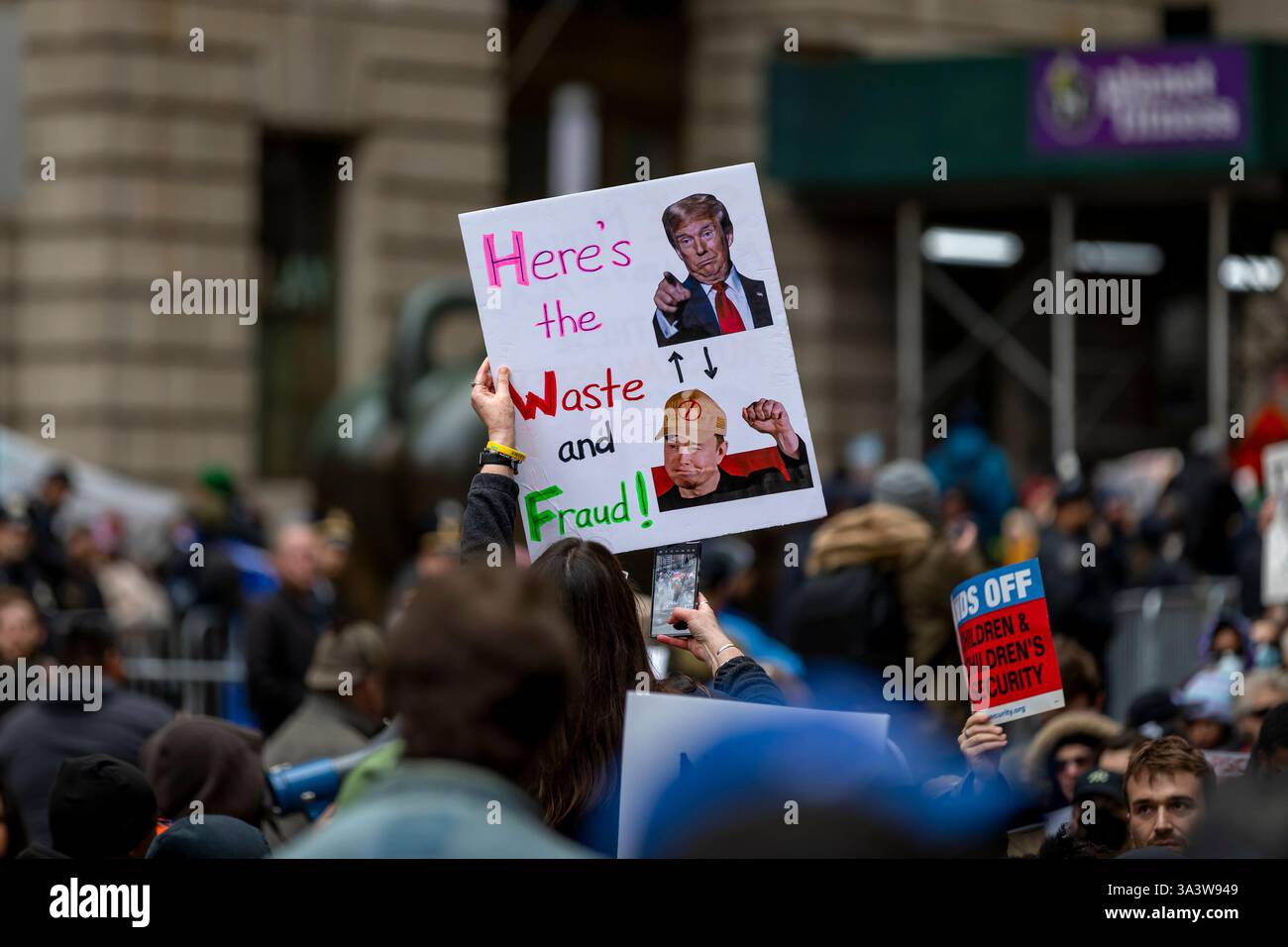 New York City, United States. 14th Mar, 2025. A protestor holds a sign ...