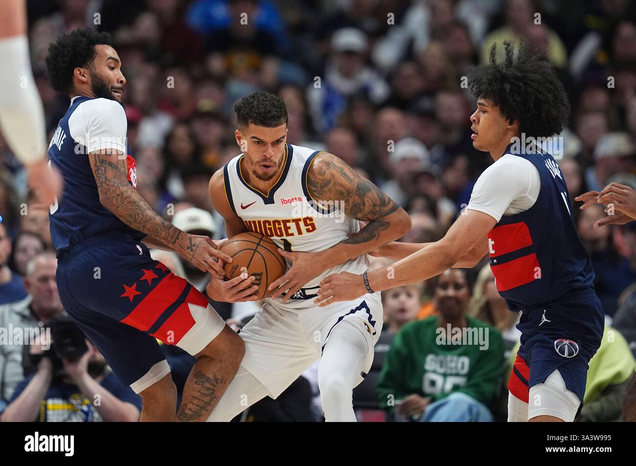 Denver Nuggets forward Michael Porter Jr., center, sturggles to hold on ...