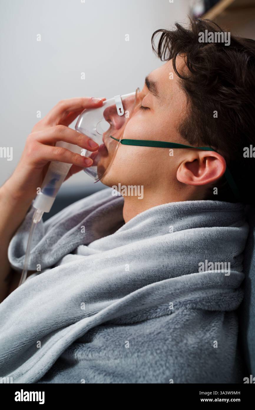 Patient inhaling through nebulizer for pneumonia treatment. Breathing ...