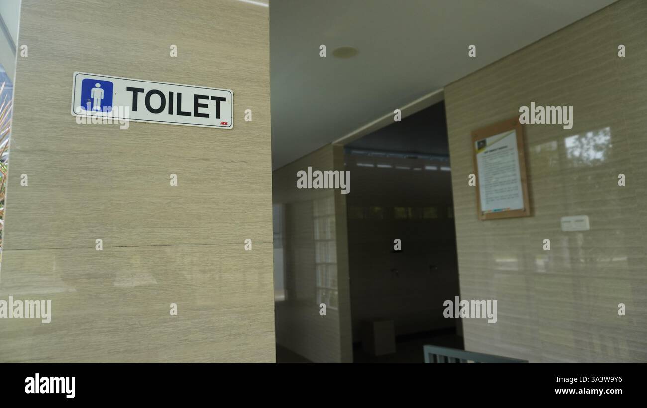 A well-maintained public restroom entrance with a clear "TOILET" sign ...